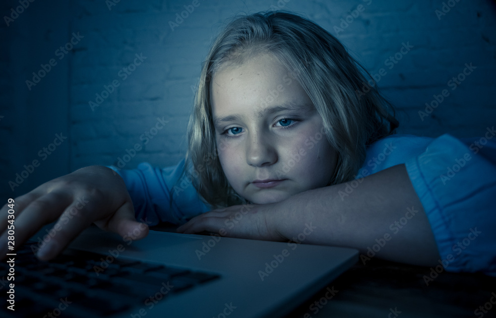 Foto de Sad young girl with laptop suffering bullying and harassment ...
