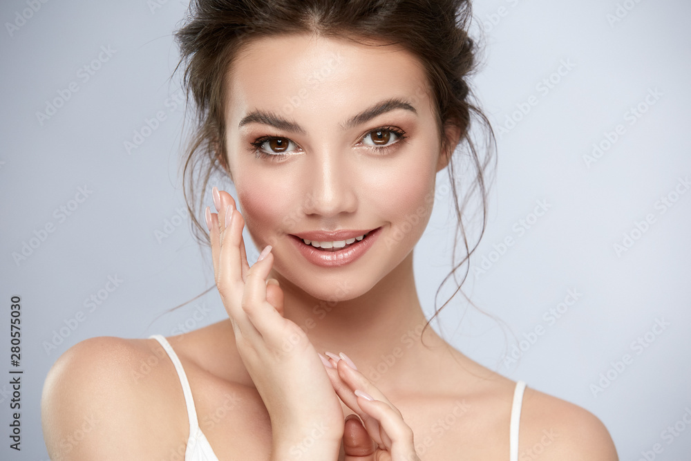 cute girl with perfect smile and glossy lips touching her cheek and ...