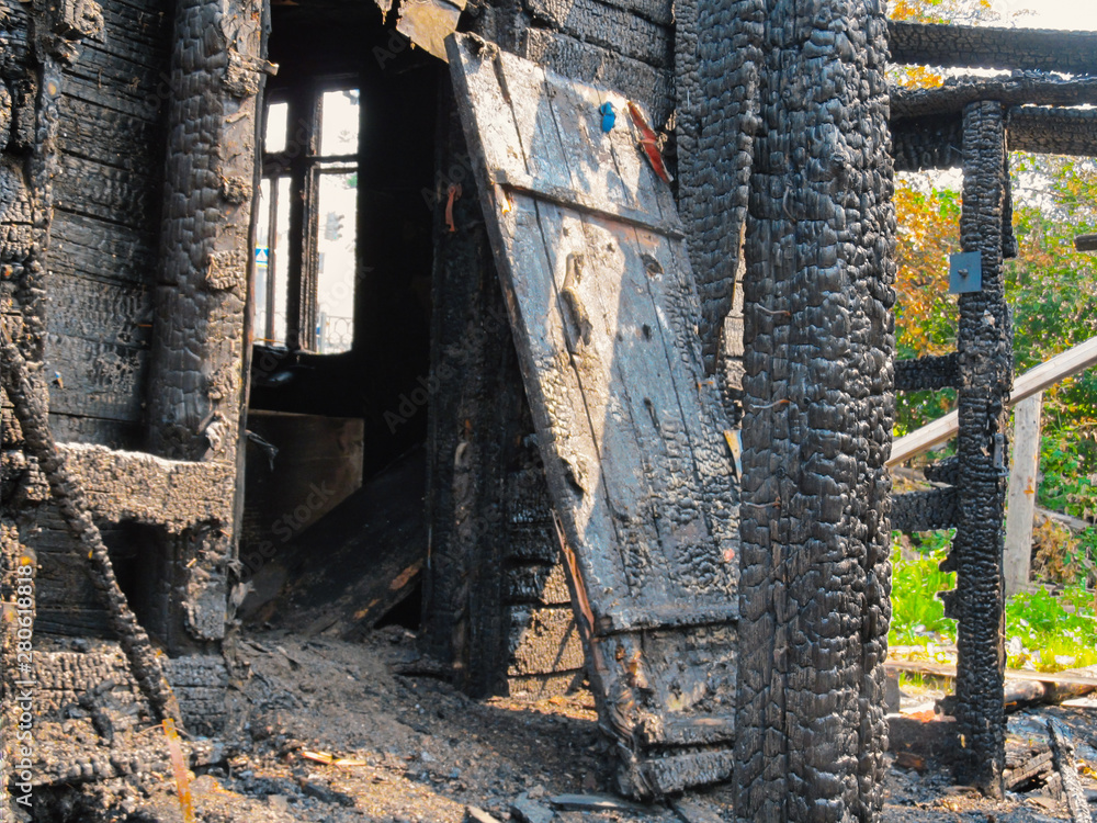 Wooden house after tragic fire. Ruined abandoned building after burnt ...