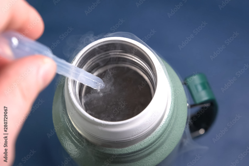 Liquid air, pouring liquefied air into thermos. Stock Photo | Adobe Stock