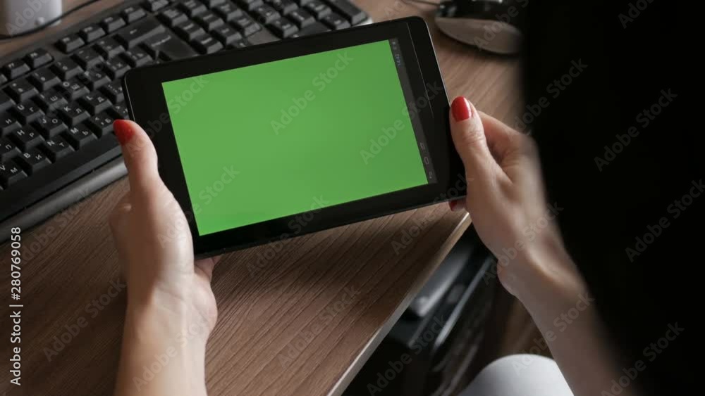 Female hands using tablet mobile with empty green screen top view work ...