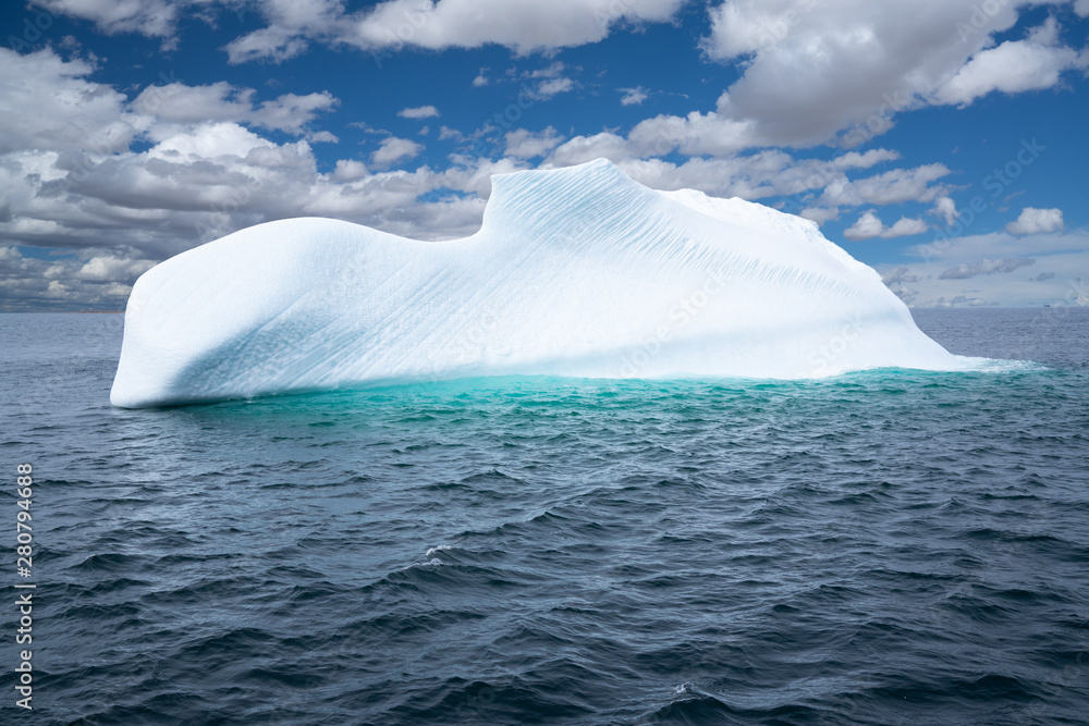 Iceberg floating in the ocean Stock Photo | Adobe Stock