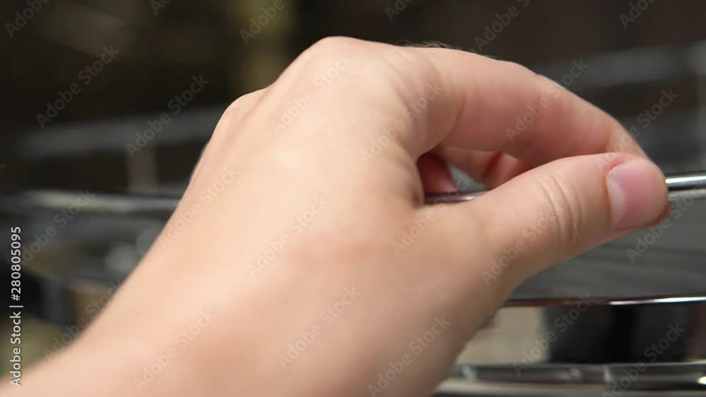 female hand touches furniture fittings for kitchen furniture a metal ...