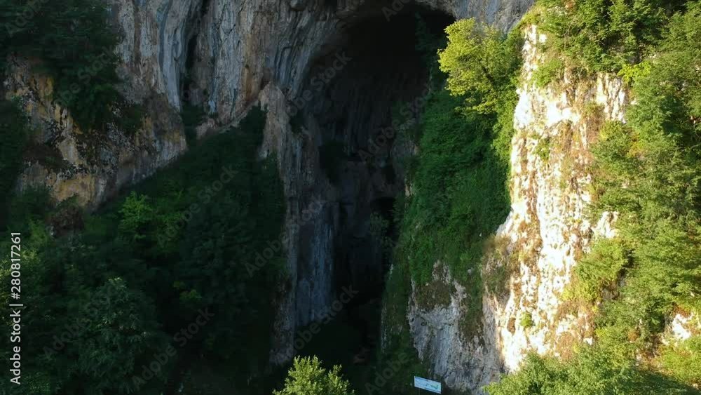 Monumental entrance into the Potpec Pecina Cave shaped like horseshoe ...