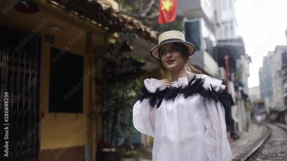 Beautiful and young fashion mestizo girl walking along the asian street ...