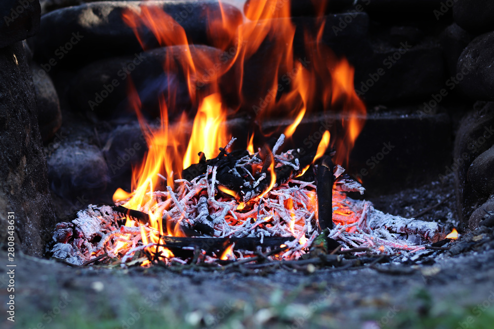 Campfire in the garden with wood burning at the afternoon. Long ...