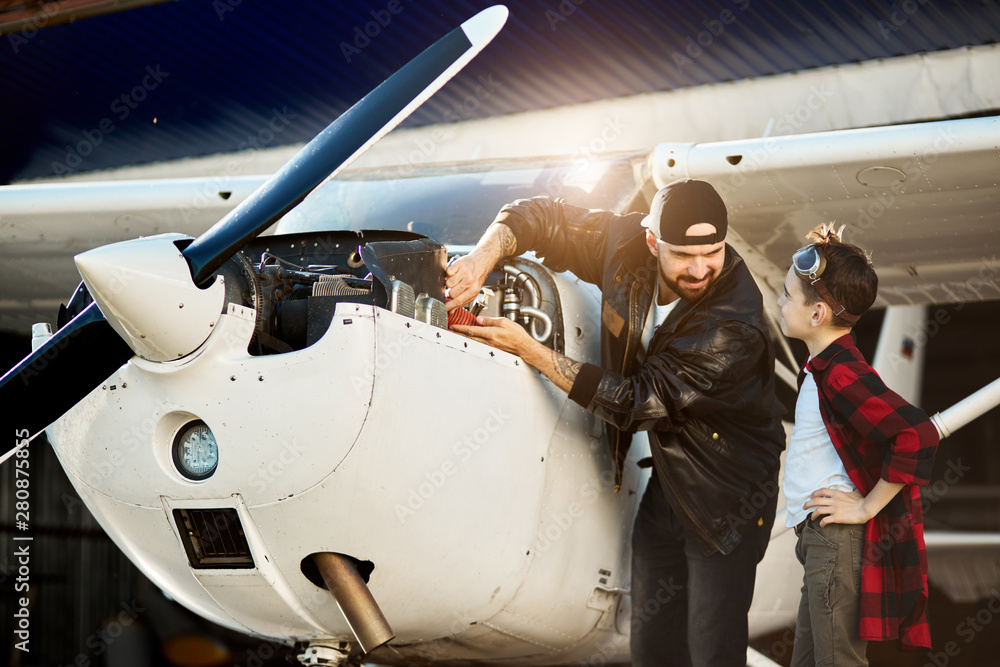young dad and his lovely boy talking about their oncoming first flight ...