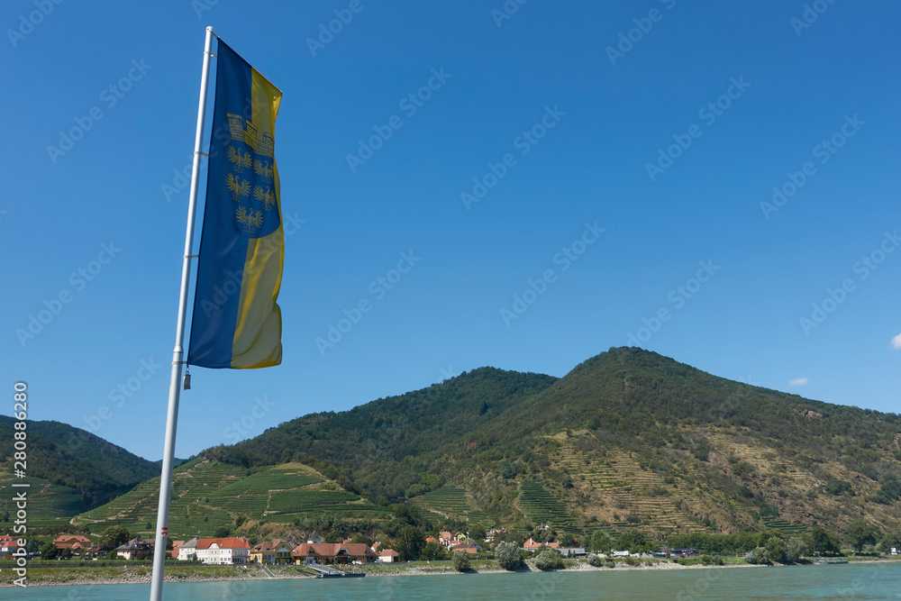 Flag of the country Lower Austria in the Wachau in front of the Danube ...