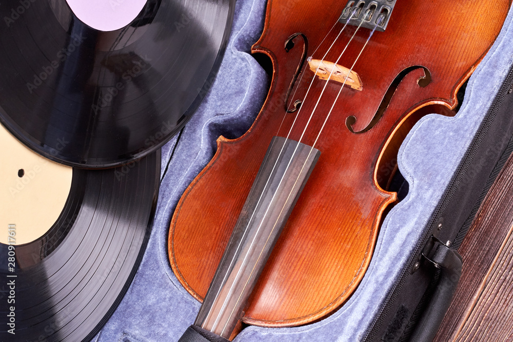 Vintage violin and vinyl records. Retro viola in velvet case. Old ...