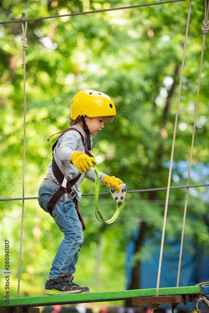 High ropes walk. Balance beam and rope bridges. Happy Little child ...