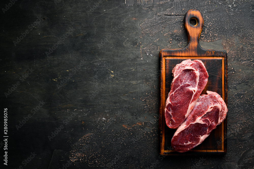 Raw marbled meat Black Angus Steak Ribeye. At the aged table. Top view ...
