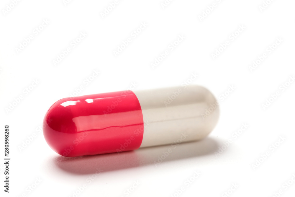 Single capsule pill on white background Stock Photo | Adobe Stock