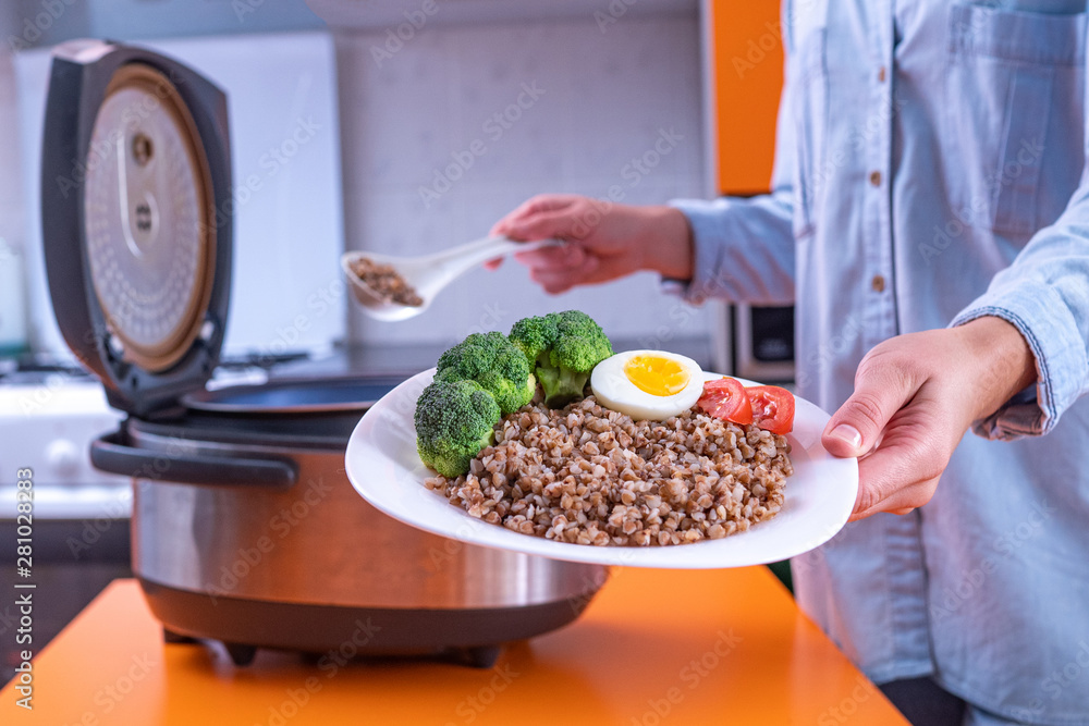 Cooking fresh meals using modern multi cooker at home Stock Photo ...