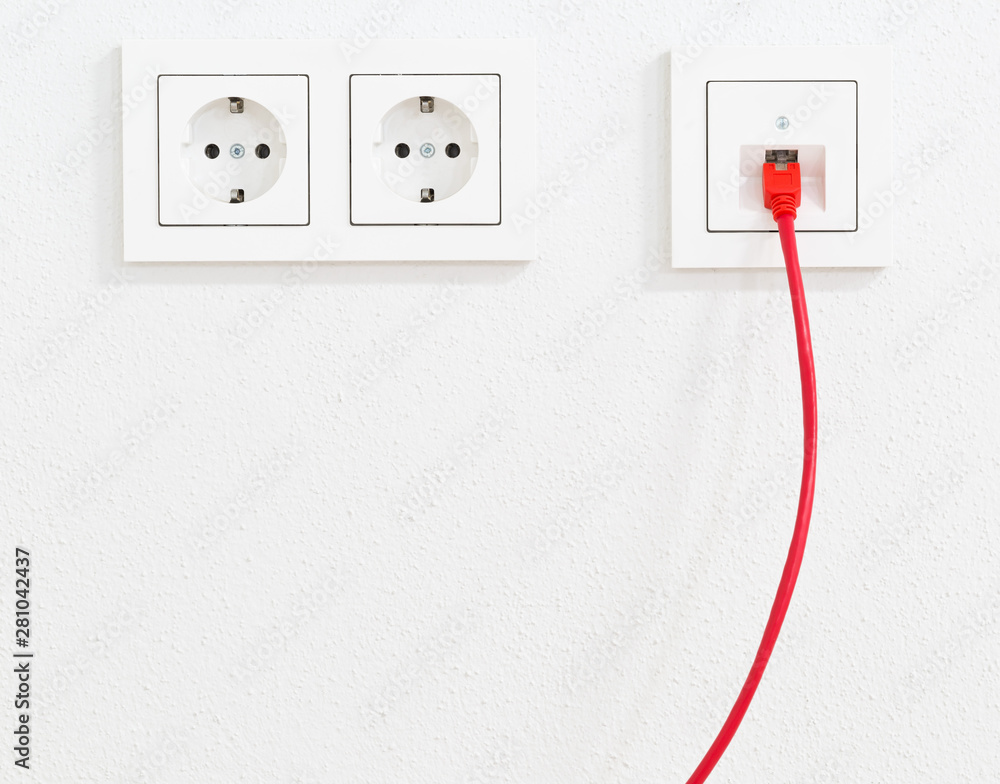 Red network cable in wall outlet for office or private home lan ...