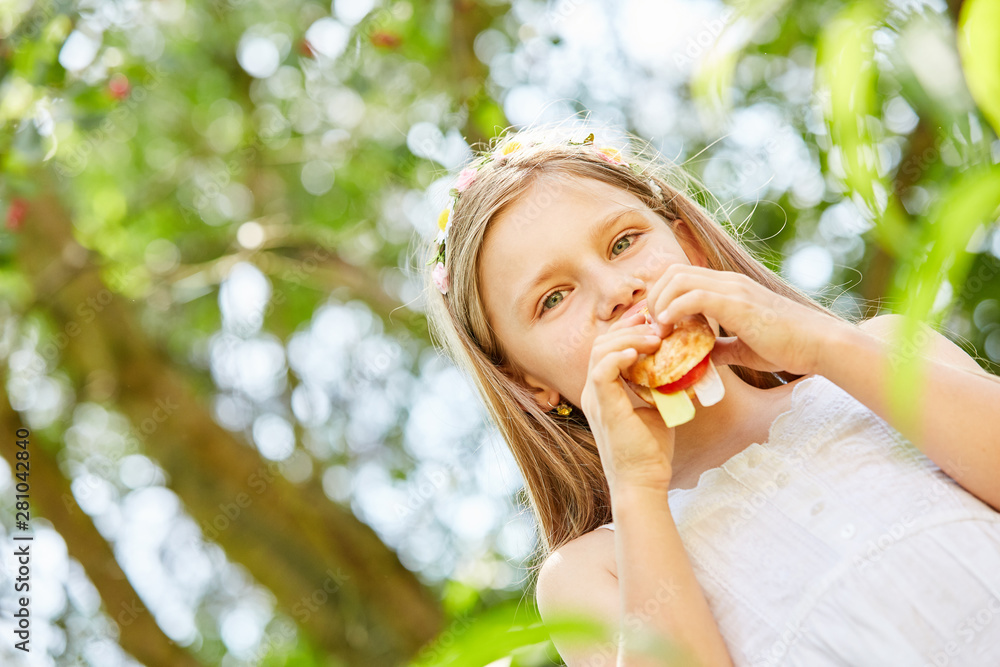 Hungry girl on a garden party Stock Photo | Adobe Stock