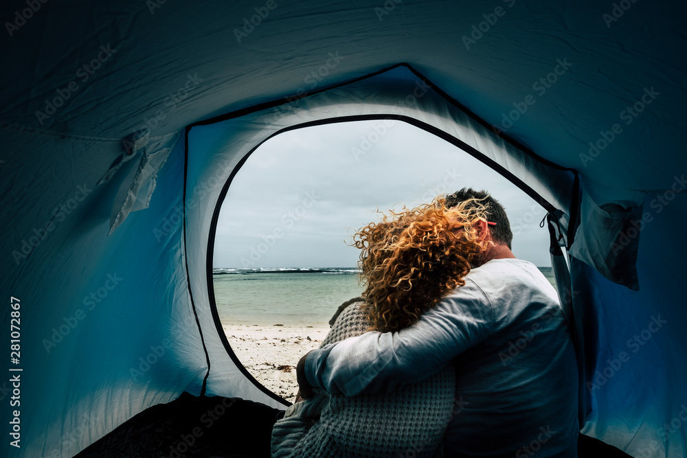 Love inside a tent in free camping at the beach for couple viewed from ...