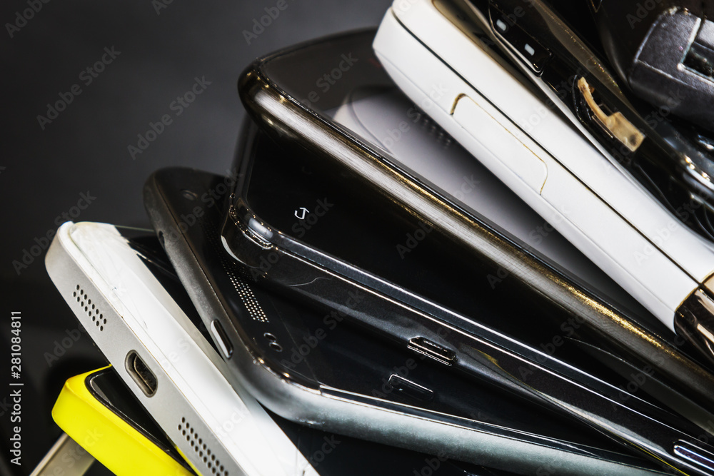 old and broken smartphones and mobile phones. Background of old phones ...
