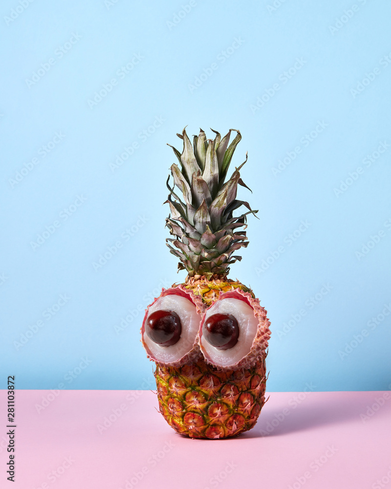 A man's face made from tropical fruits - pineapple and the eye of half ...