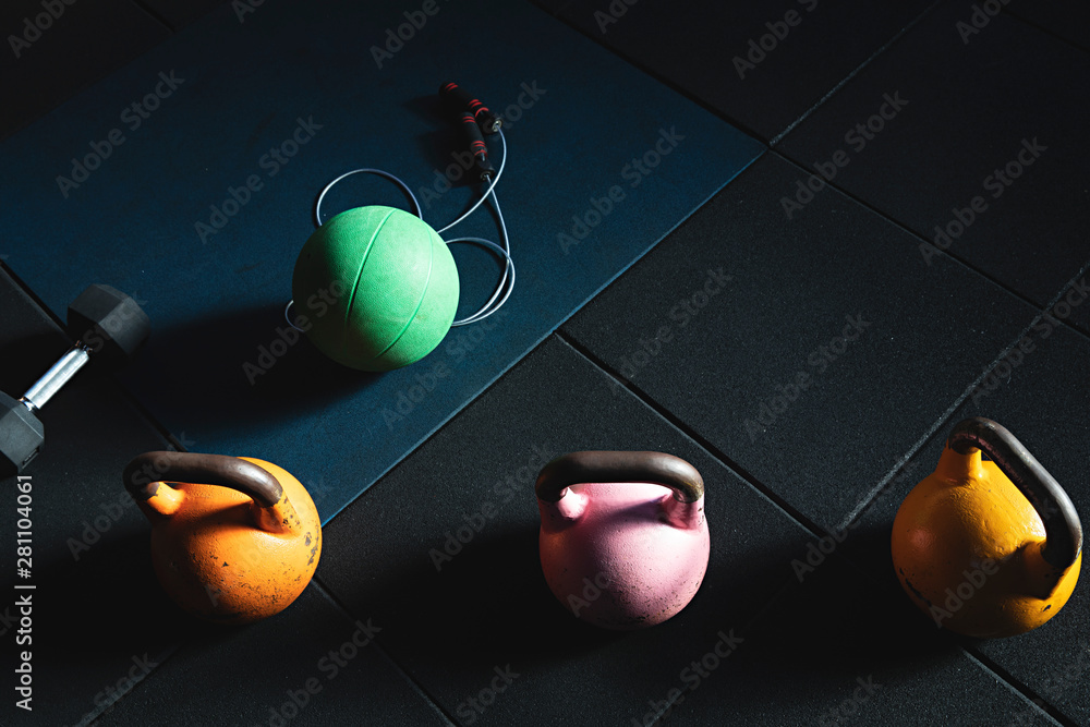 Colourful gym and weight training equipment on floor of a fitness ...