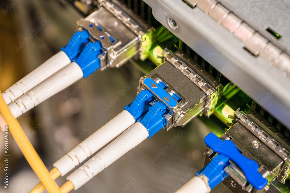 The fiber optic wires are connected to the optical interfaces of the ...