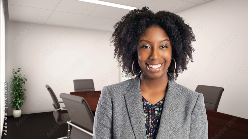 Black African American businesswoman in an office smiling happy. She is ...