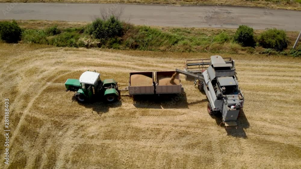 Aerial view gray combine harvester with full hopper auger unloading ...