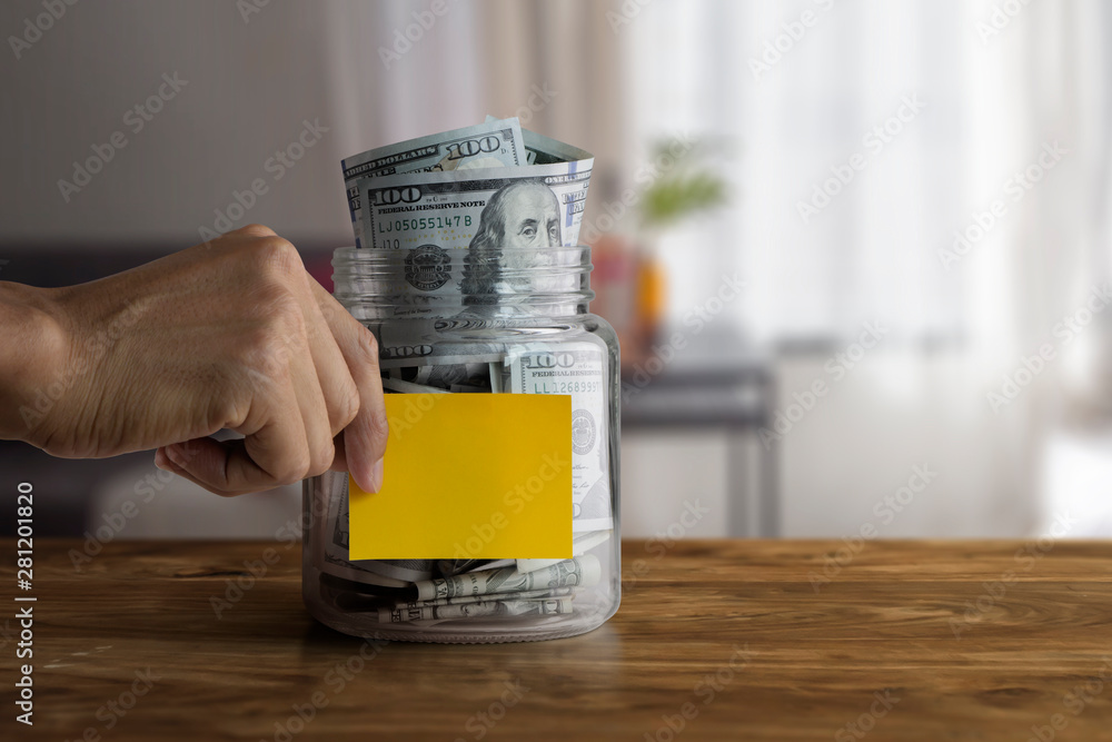 Money savings concept. Man is holding a blank sticky note for input any ...