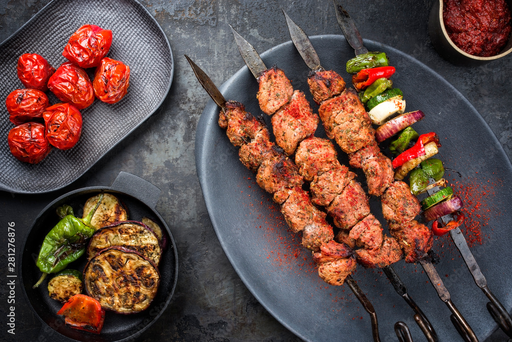Traditional Russian shashlik on a barbecue skewer with vegetable and ...