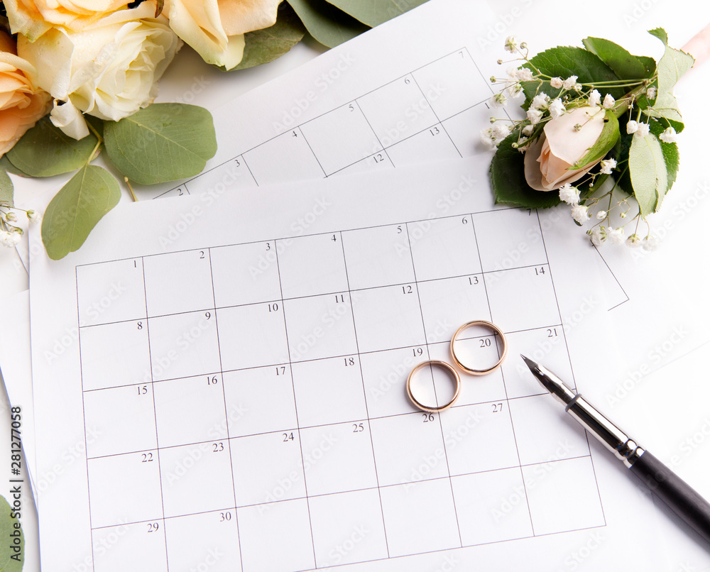Planning the wedding date on calendar with gold rings and roses Stock ...