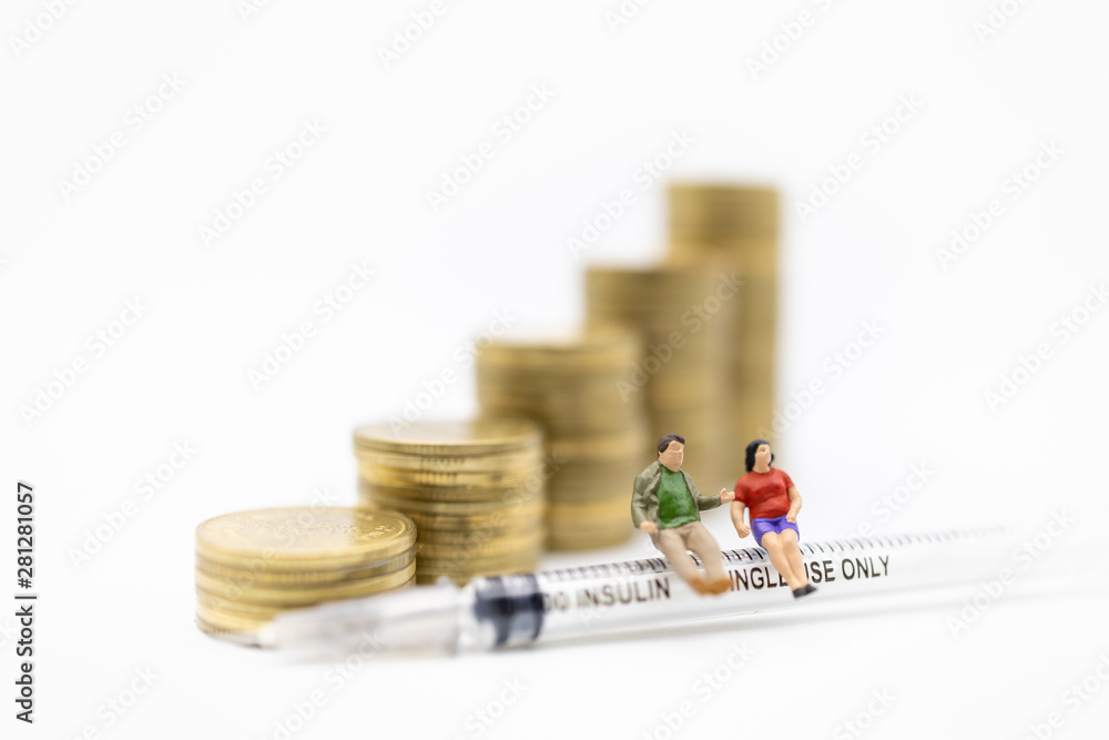 Fat man and woman miniature figure sitting on insulin syringe for ...