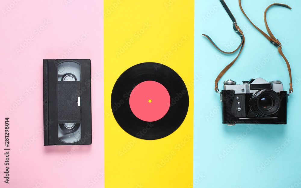 Retro still life. Vinyl record, vintage film camera, video cassette on ...