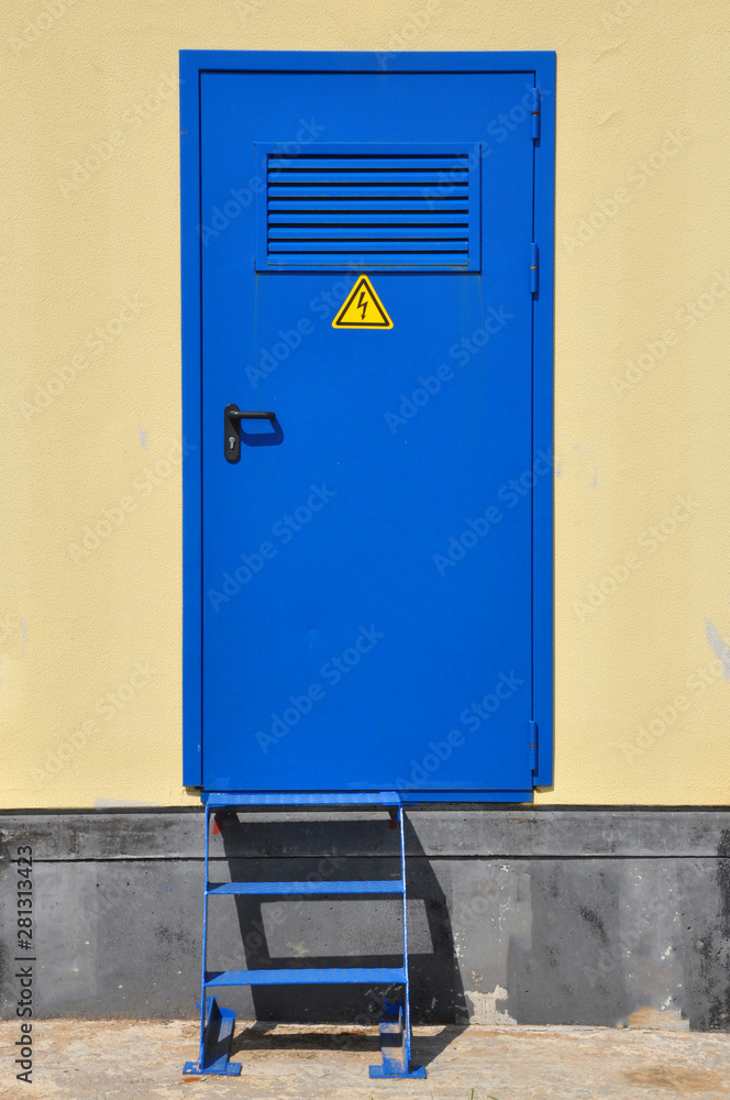 Iron blue door of a transformer box. Electricity, high voltage, do not ...