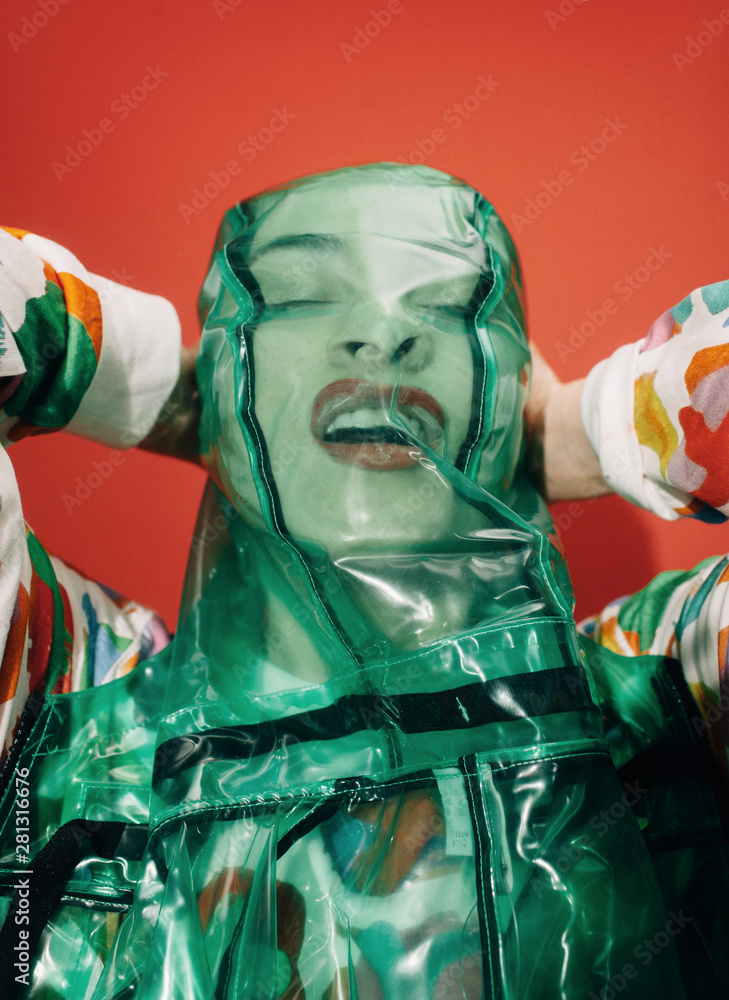 Woman squeezing face with plastic fabric Stock Photo | Adobe Stock