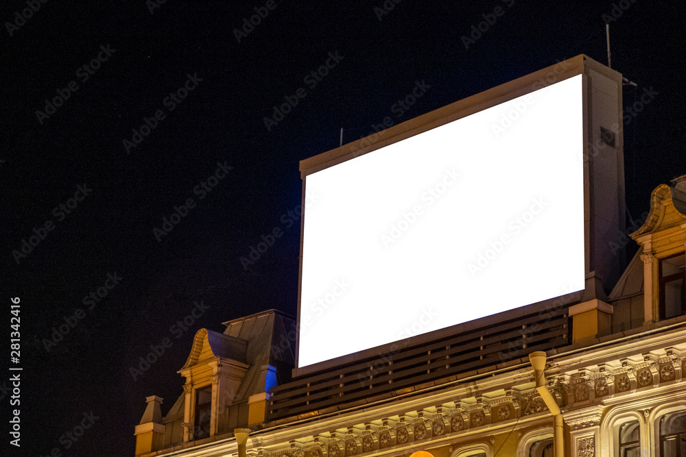 huge Billboard on the building in the night city, night advertising ...