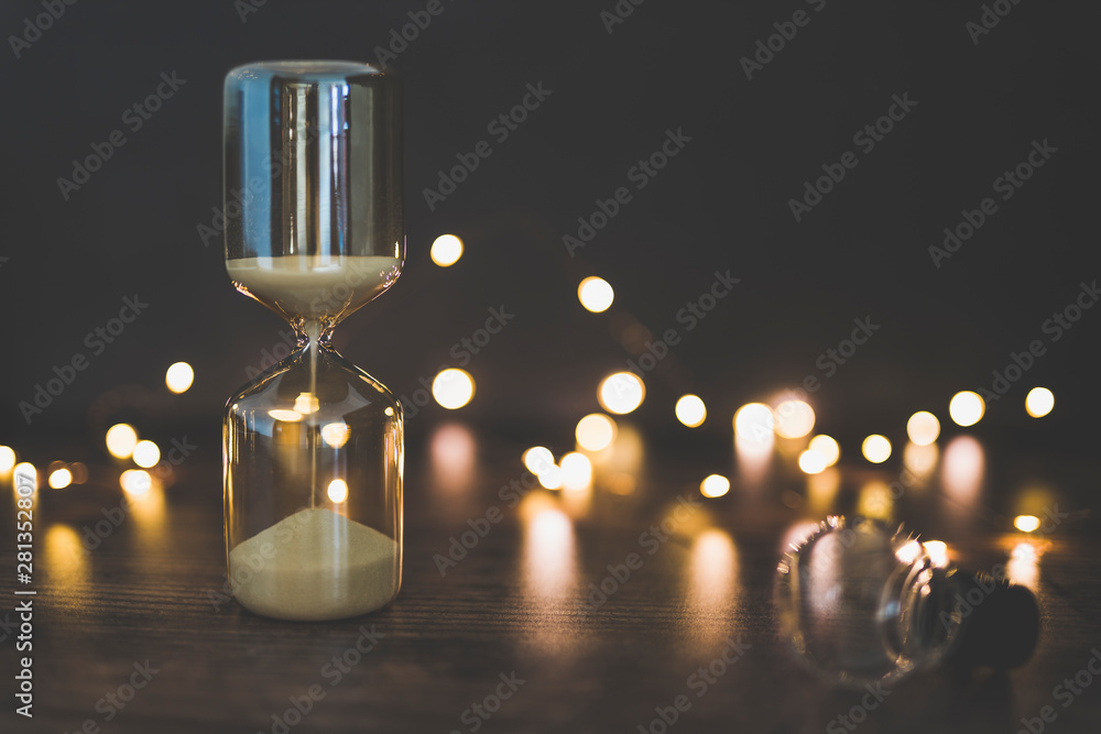 time for new ideas hourglass and lightbulb surrounded by fairy lights ...