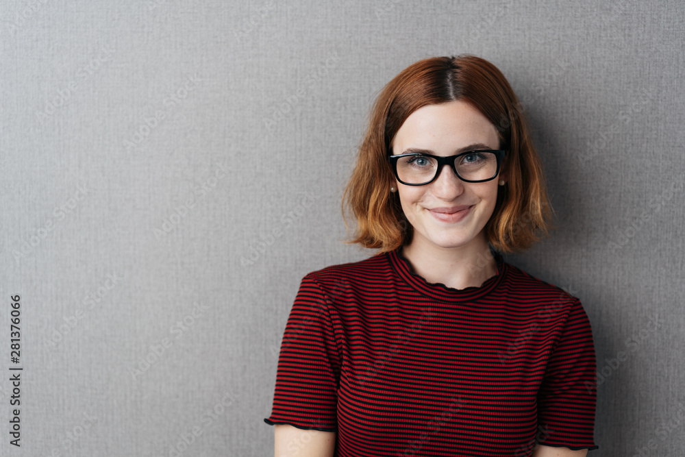 Foto de Smiling studious woman in heavy rimmed glasses do Stock | Adobe ...