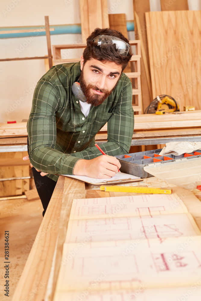 Young craftsman with a construction drawing Stock Photo | Adobe Stock