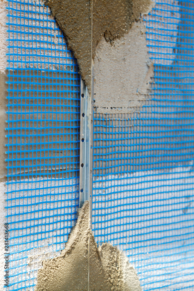 surface of wall with applied construction grid and guides for plaster ...