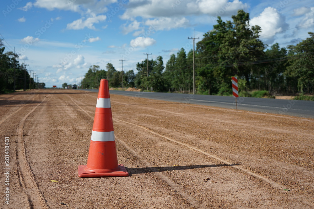 Red rubber cone is placed on the road during the construction of the ...