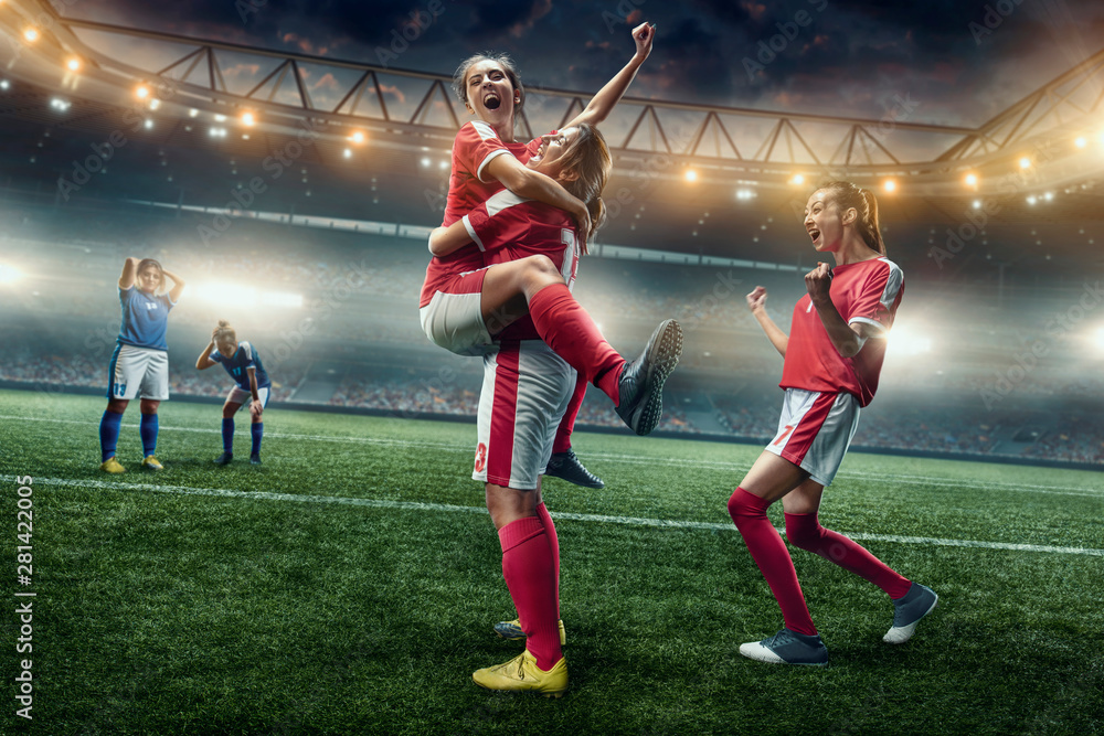 Foto de Happy Female Soccer players on a professional soccer stadium ...