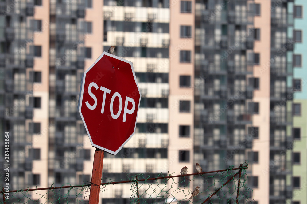 Stop sign on the residential building background, entry is prohibited ...