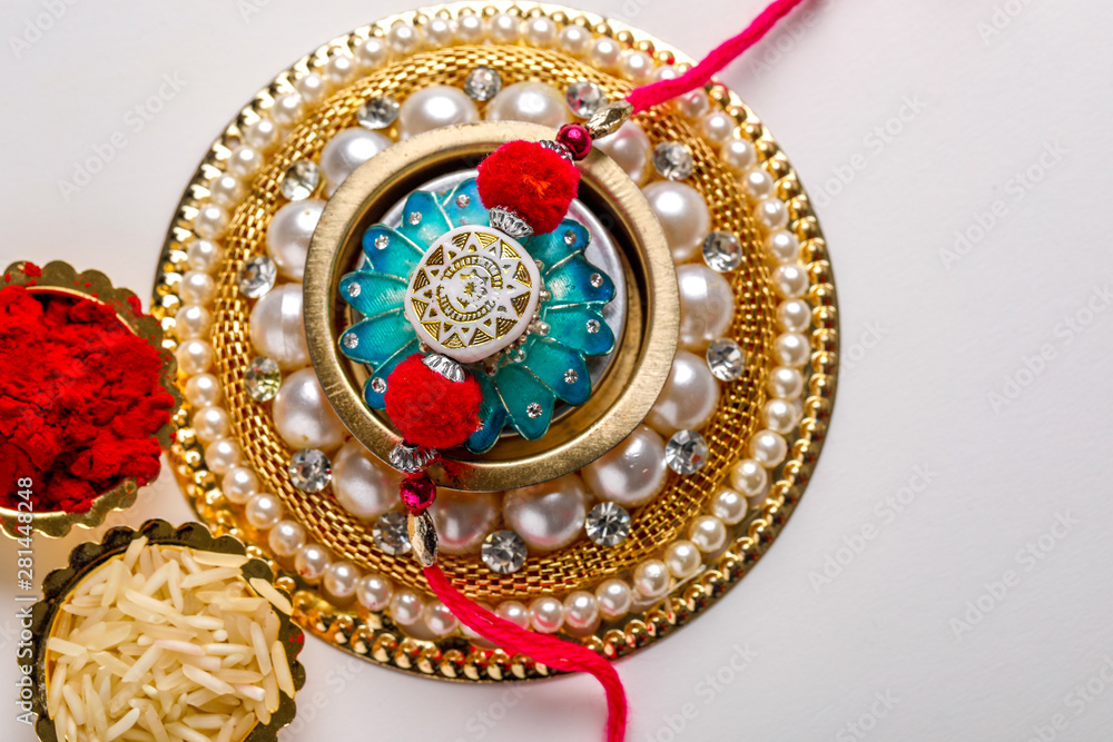 Indian festival Raksha Bandhan , Rakhi with rice grains, kumkum on ...