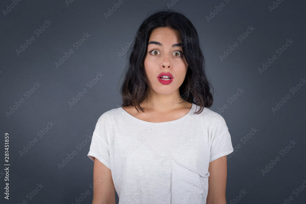 Headshot of goofy surprised bug-eyed young woman student wearing casual ...