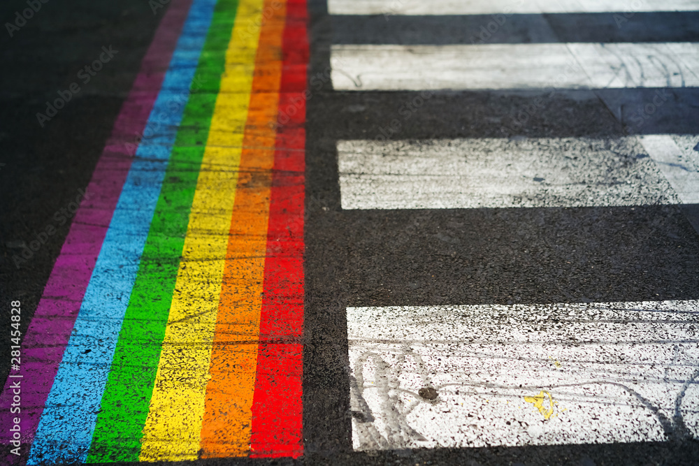 Road marking of pedestrian crossing and rainbow flag in Paris. Sex ...
