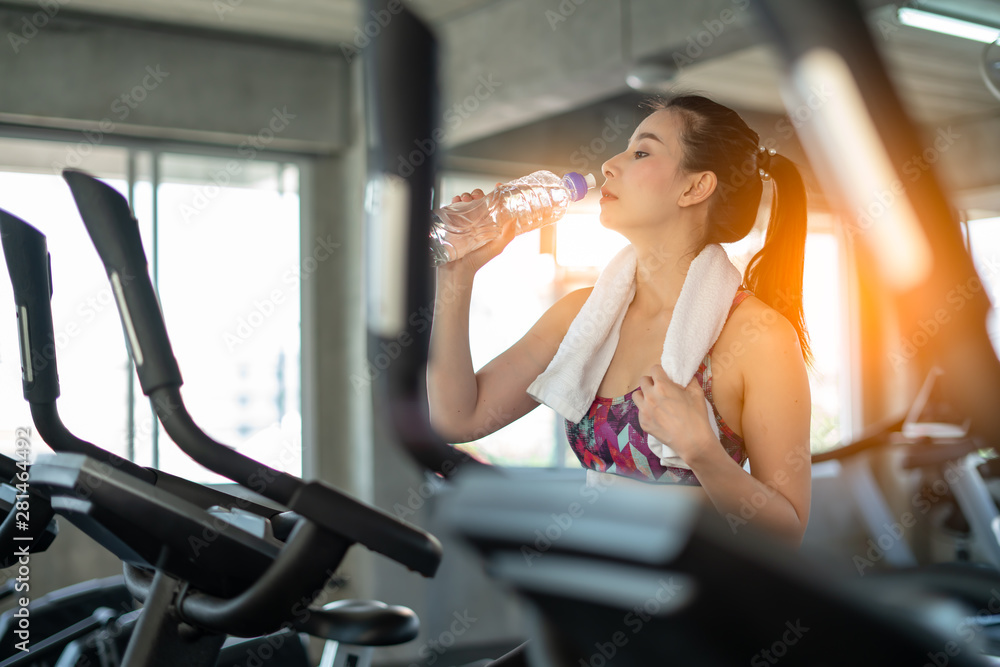Gym woman working out drinking water smiling happy.young asian girl ...