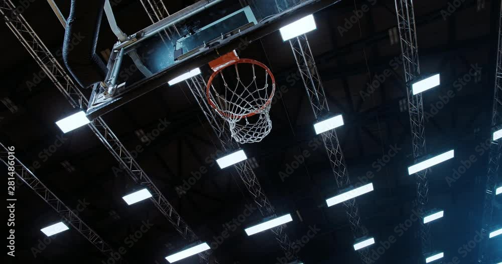 Low angle of professional basketball player in action performing slam ...