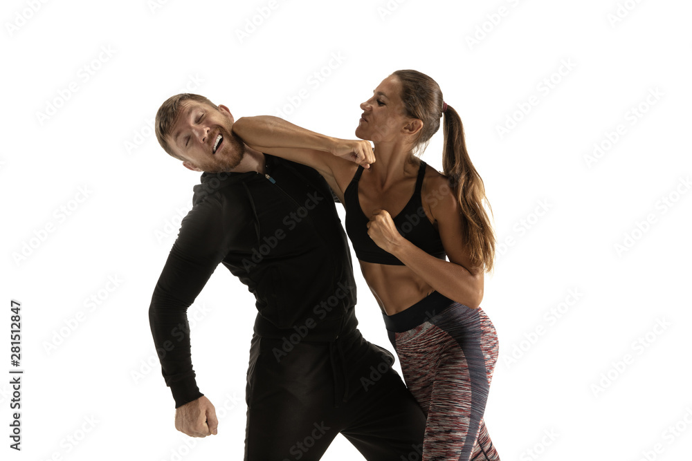 Man in black outfit and athletic caucasian woman fighting on white ...