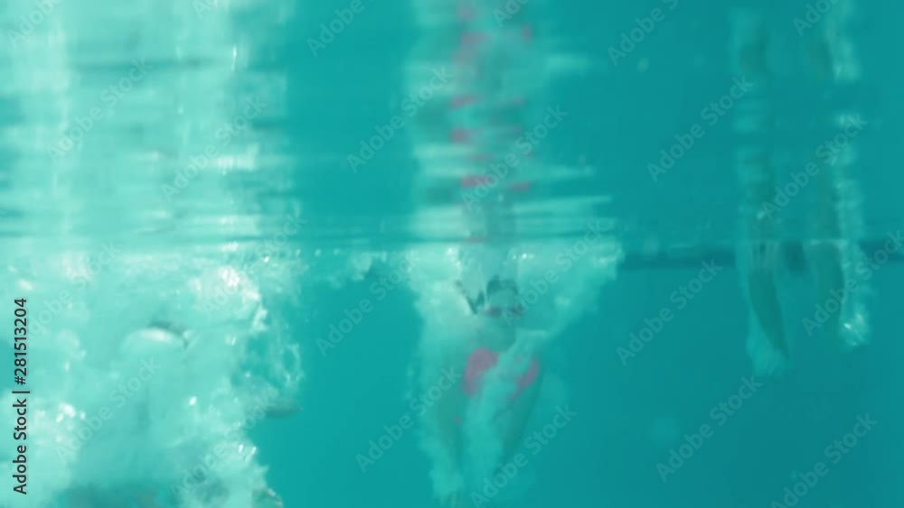 happy children jumping in swimming pool splashing underwater playfully ...