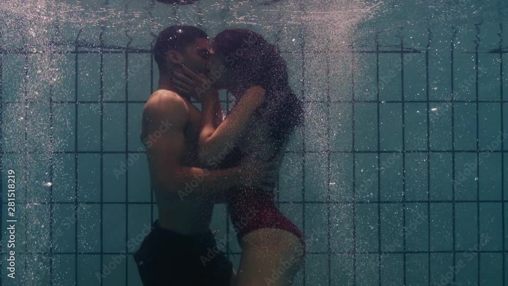 underwater couple kissing in swimming pool young people in love enjoying romantic kiss ...