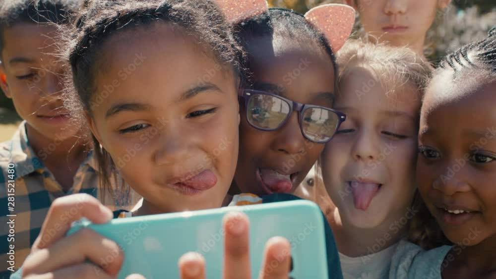 happy children using smartphone posing for photos little girls having ...